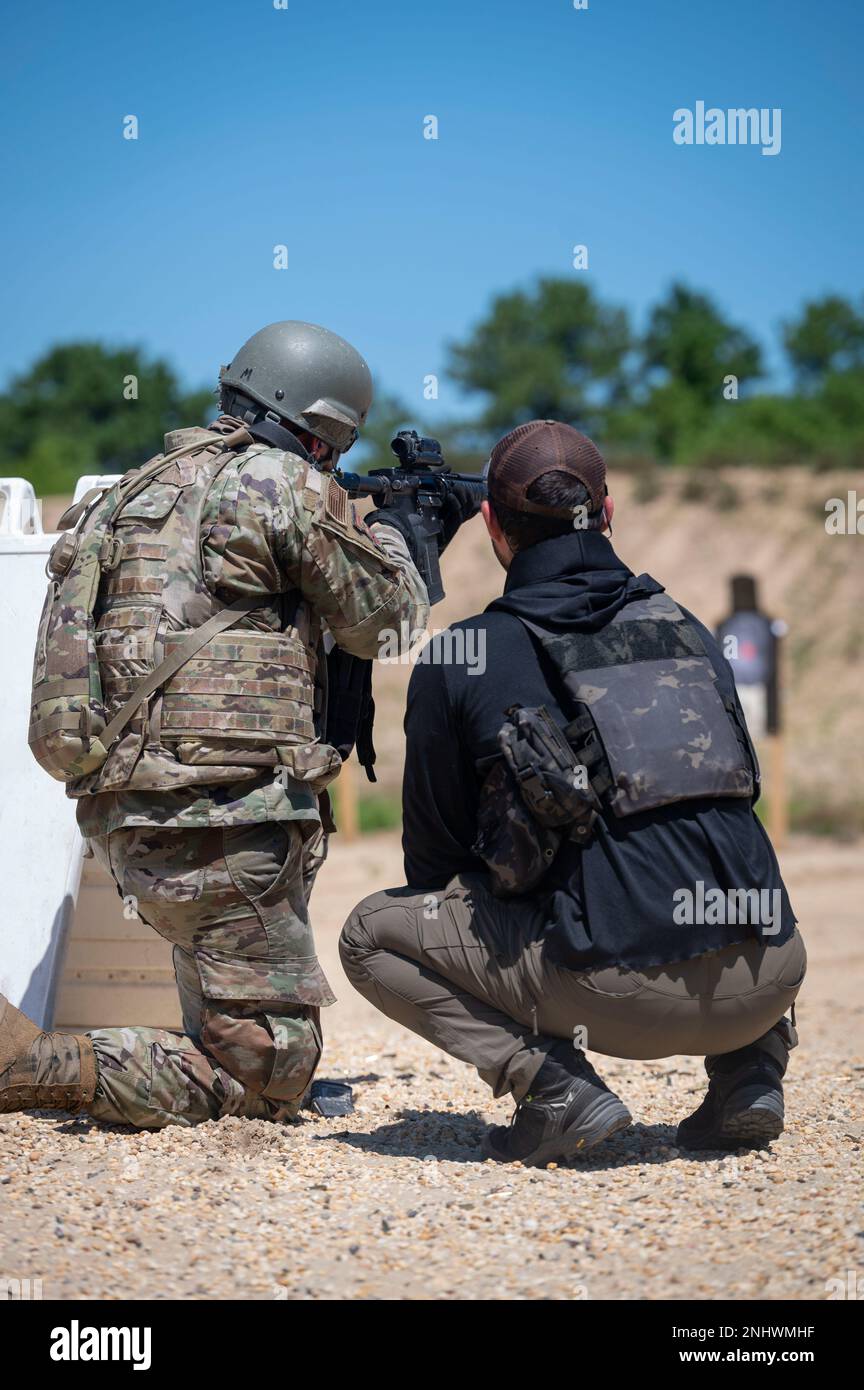 A 421st Combat Training Squadron instructor works with an Airman during weapons training at ...
