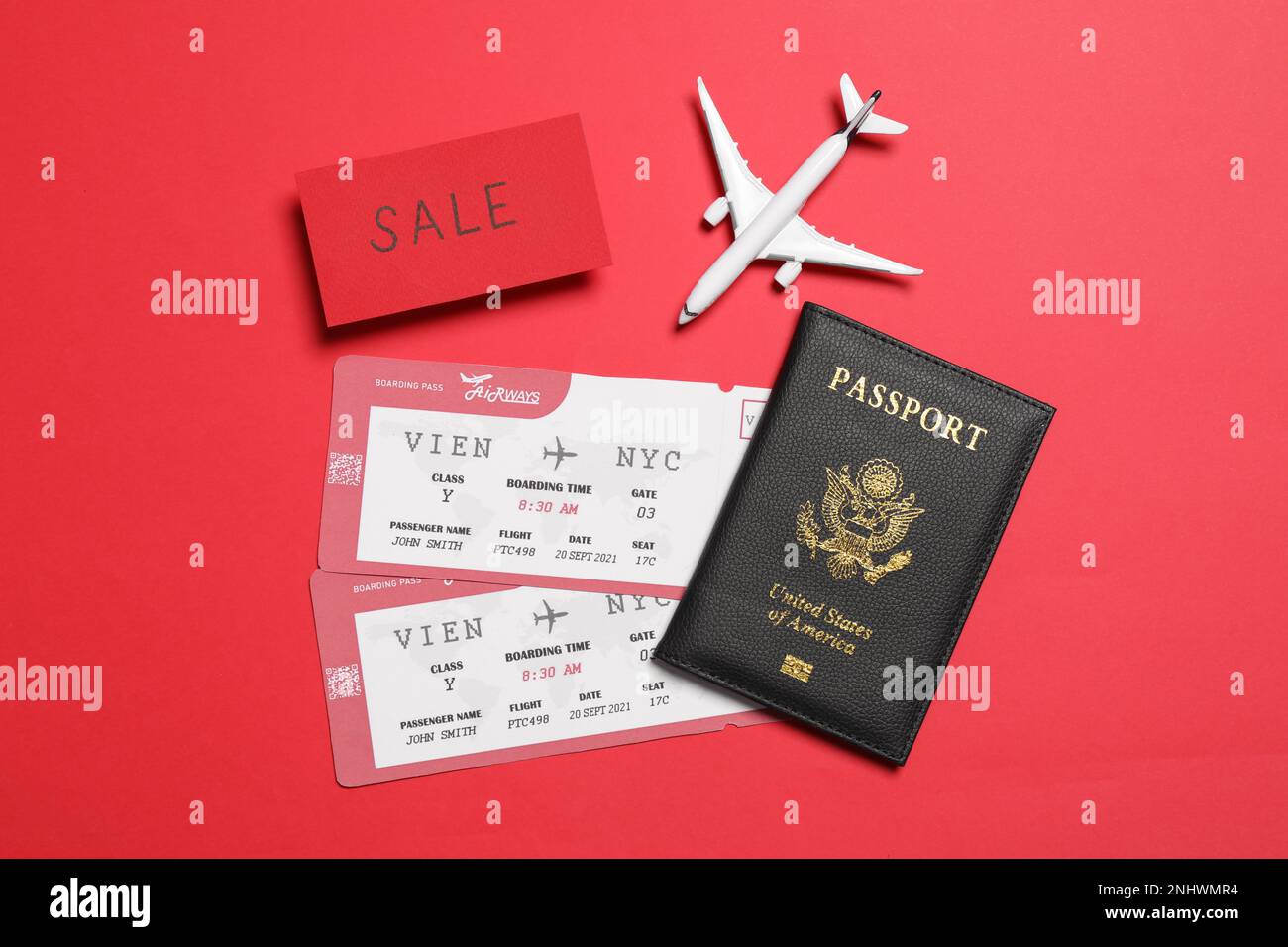 Flight tickets, passport, plane model and SALE card on red background ...