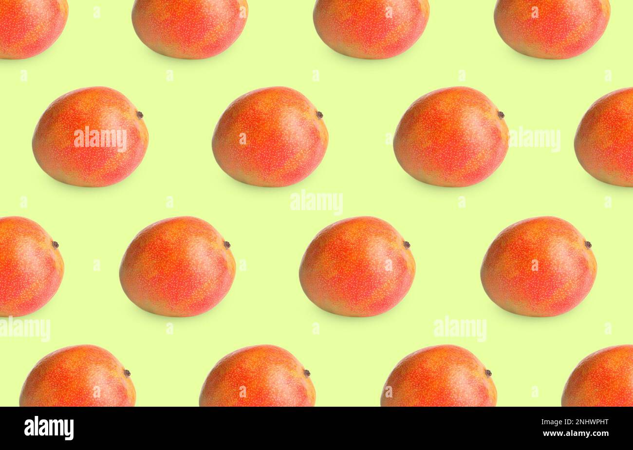 Delicious ripe mangoes on light green background Stock Photo - Alamy