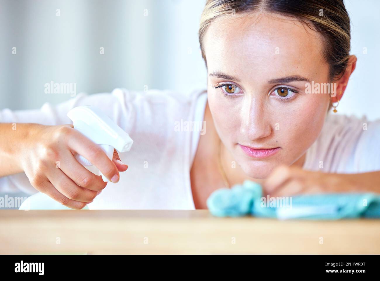 Spray, looking and woman cleaning table of dirt, bacteria and product ...