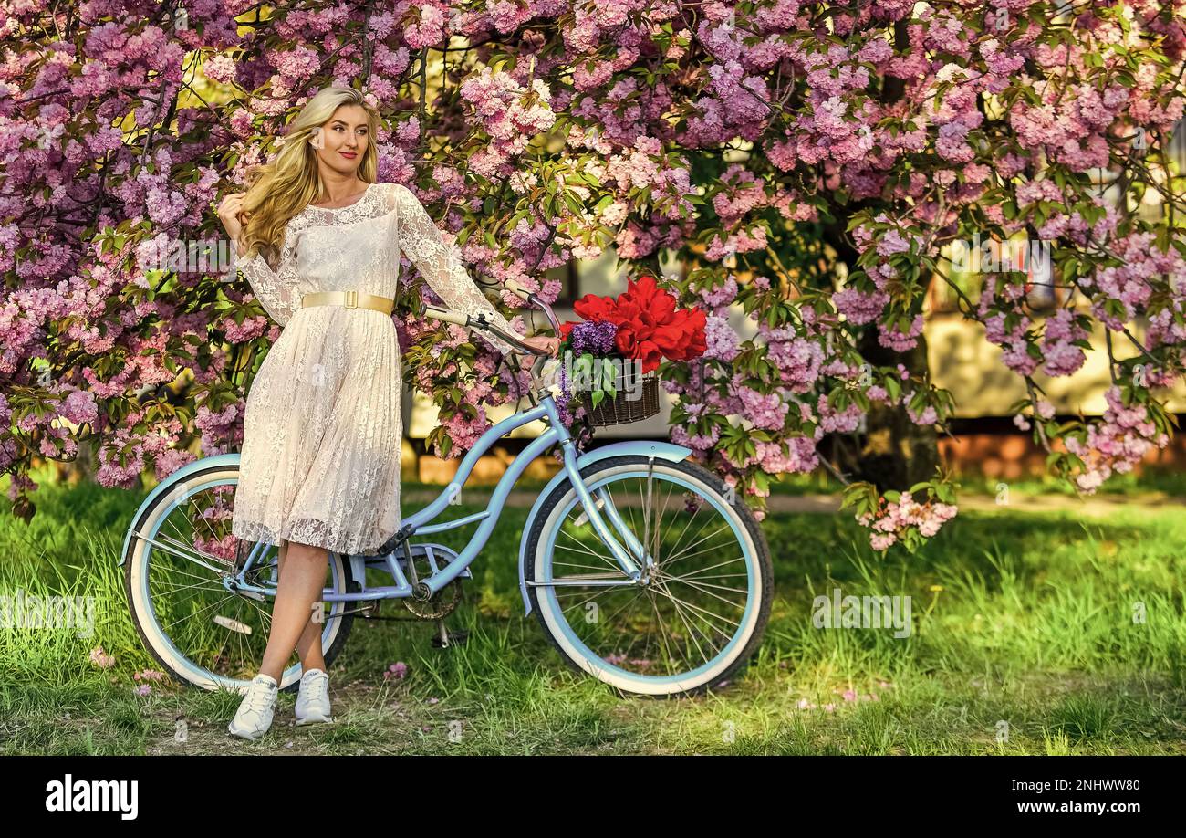Nice bouquet. lady walk in park. pink cherry tree blossom. girl carry ...