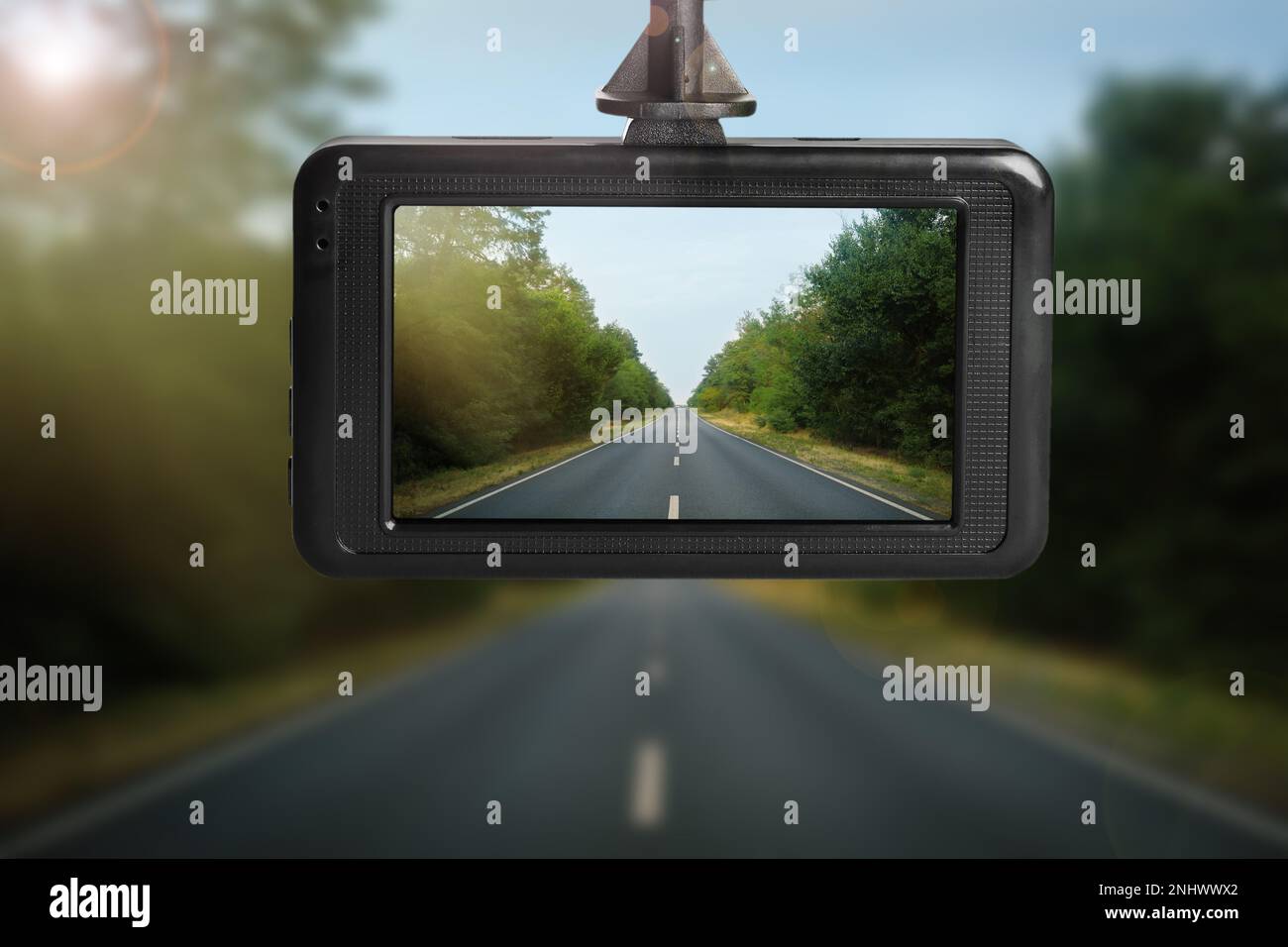Modern dashboard camera mounted in car, view of road during driving ...