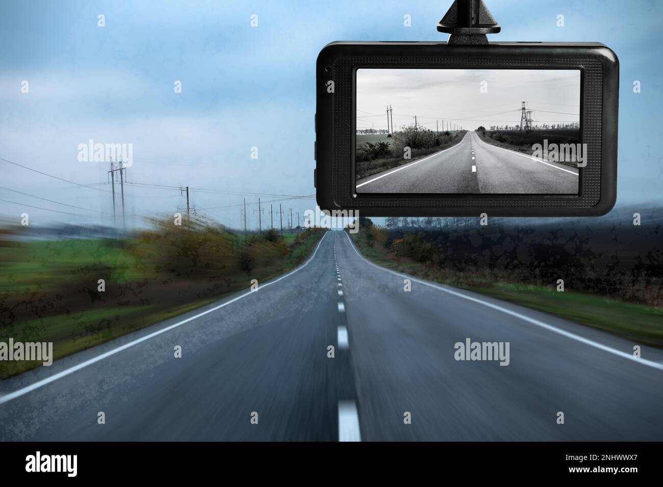 Modern dashboard camera mounted in car, view of road during driving ...