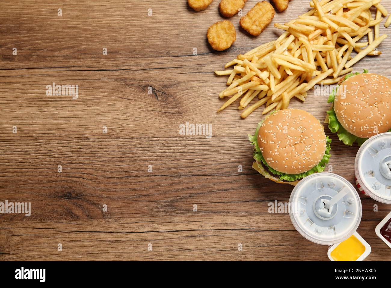 Flat lay composition with delicious fast food menu on wooden table ...