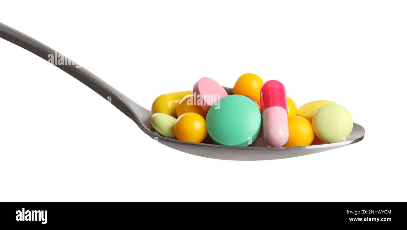 Spoon with different colorful pills on white background Stock Photo - Alamy