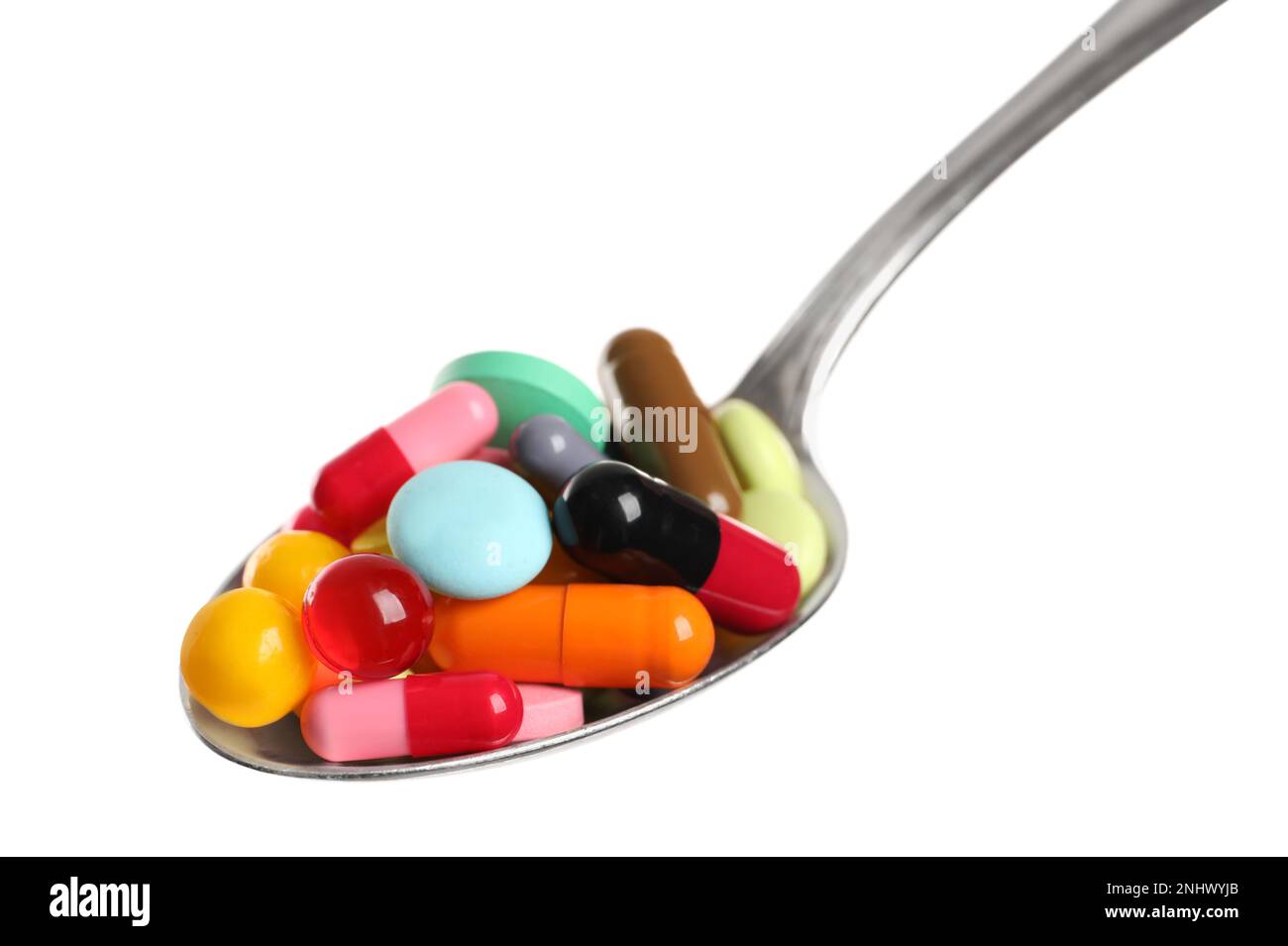 Spoon with different colorful pills on white background Stock Photo - Alamy