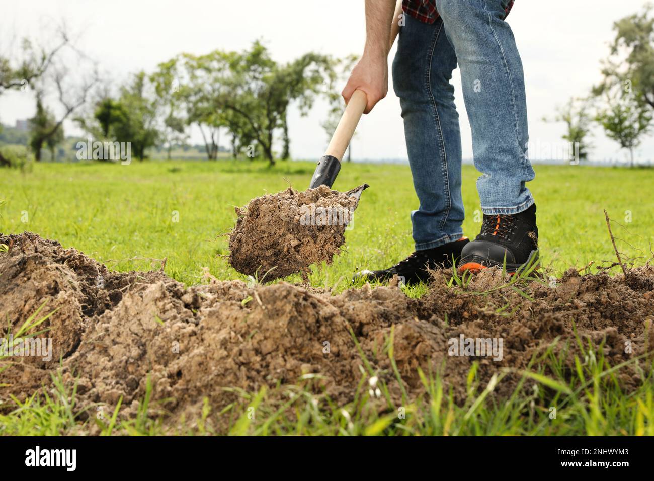Worker digging soil with shovel outdoors, closeup Stock Photo - Alamy