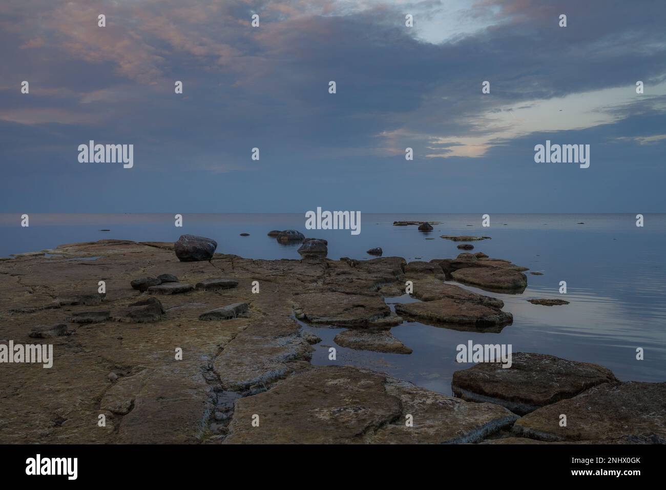 Beautiful sea shore view with with moss-covered rocks. Algae growing on ...