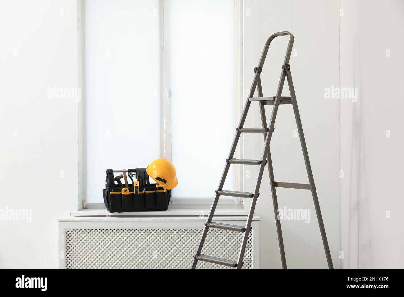 Window sill with tool box and ladder in room Stock Photo - Alamy