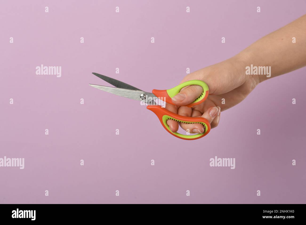 Woman holding office scissors on lilac background, closeup Stock Photo ...