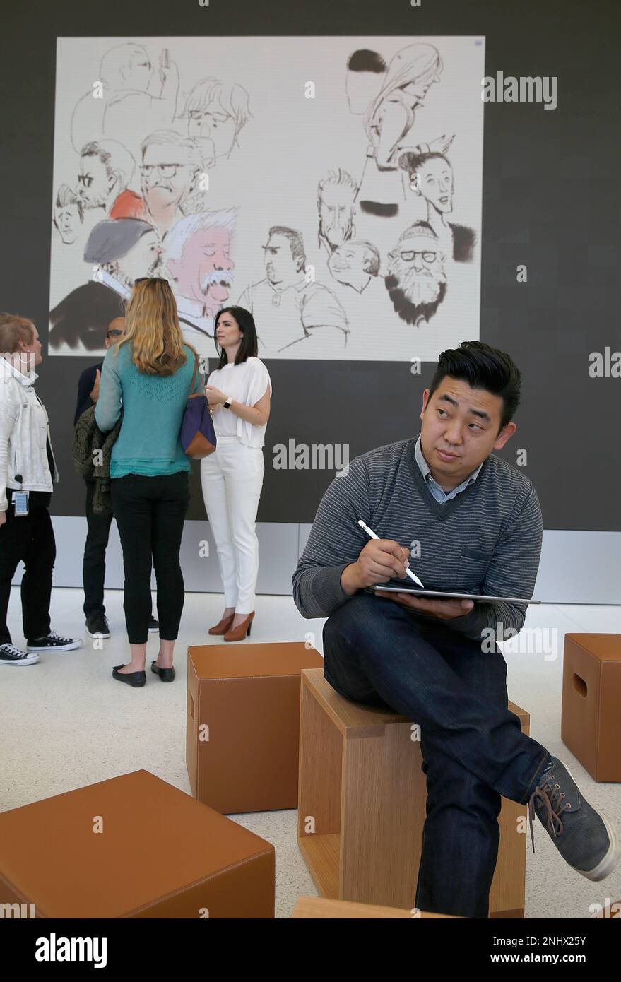 Tonka House director Robert Kondo (right) draws art on an iPad at the ...
