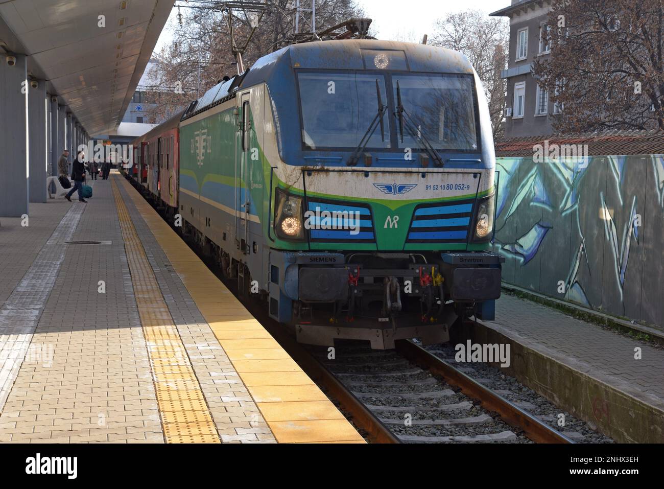 Passengers getting on a train hauled by a Seimens Vectron electric ...