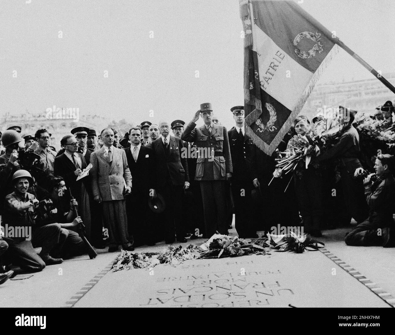 General Charles De Gaulle salutes the Tricolor after placing his wreath ...