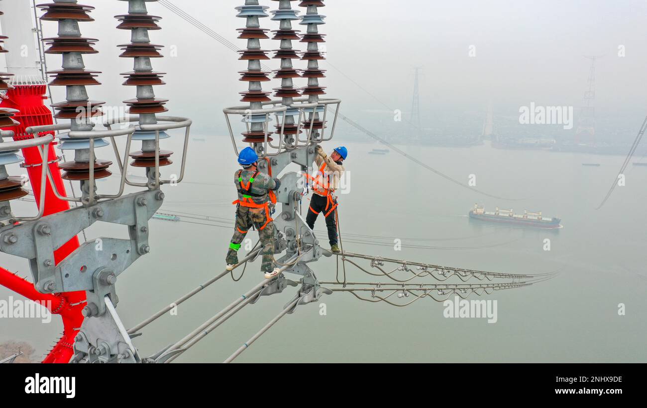 Aerial photo shows workers checking the wires of the world's highest transmission tower in Wuxi ...