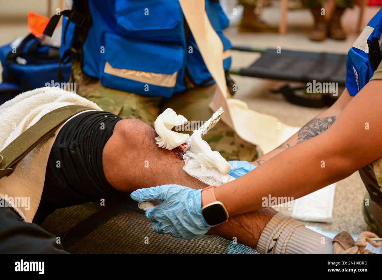 Airmen from the 5th Medical Group wrap a compression bandage around a ...