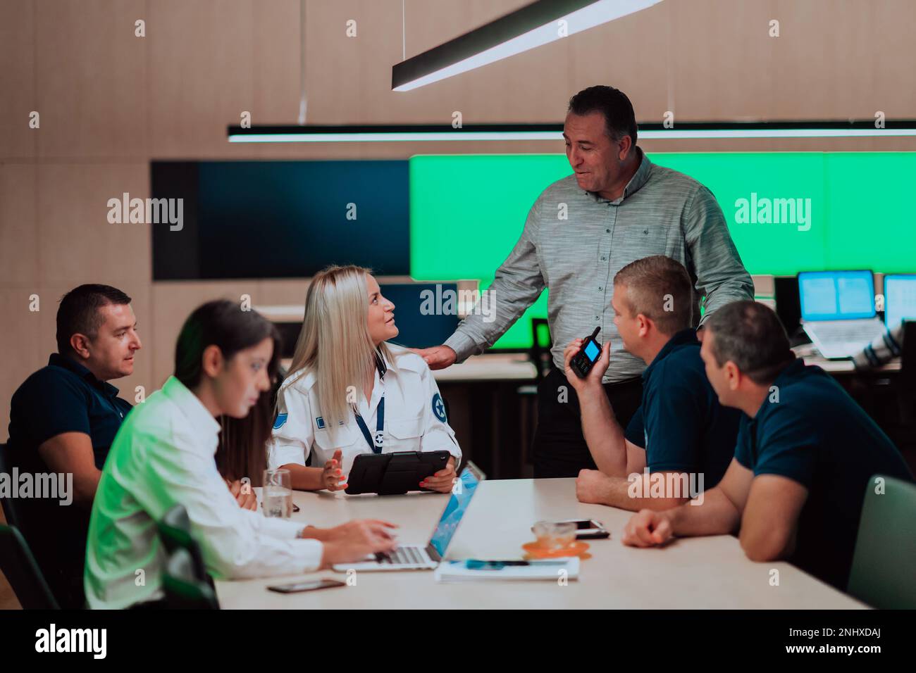 Group of security guards sitting and having briefing In the system ...