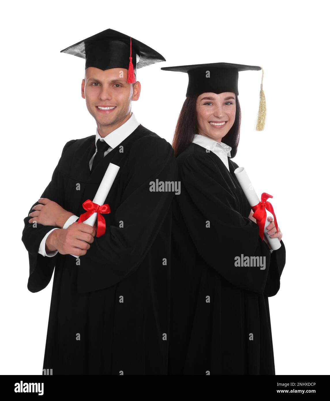 Happy students in academic dresses with diplomas on white background ...