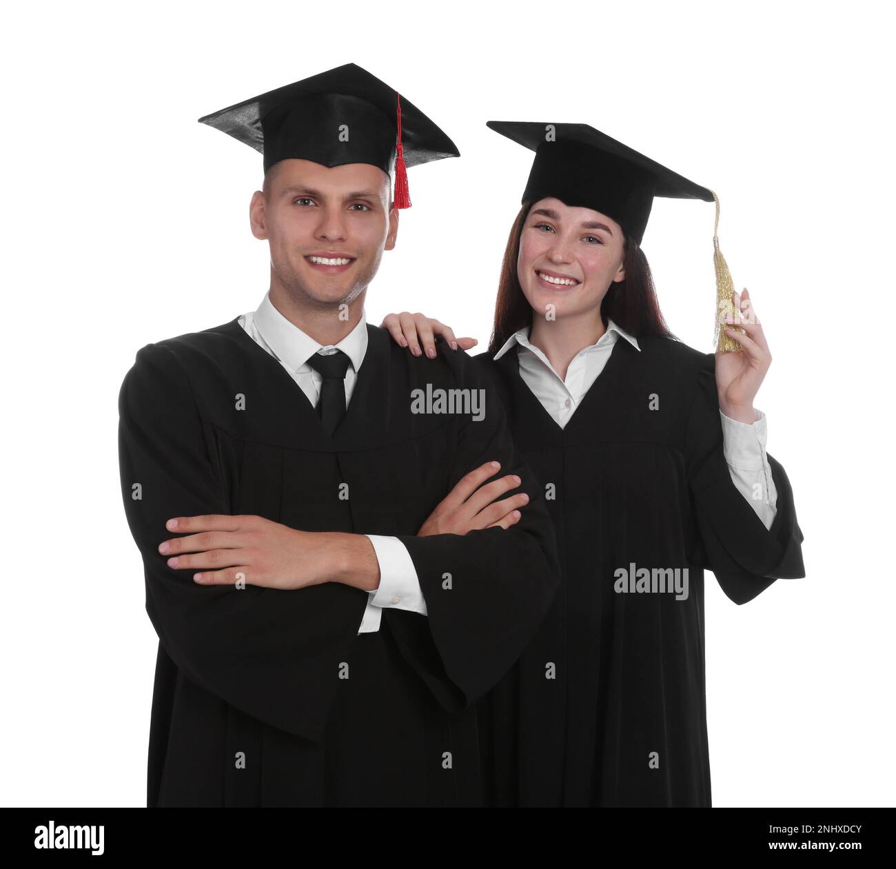 Happy students in academic dresses on white background Stock Photo - Alamy