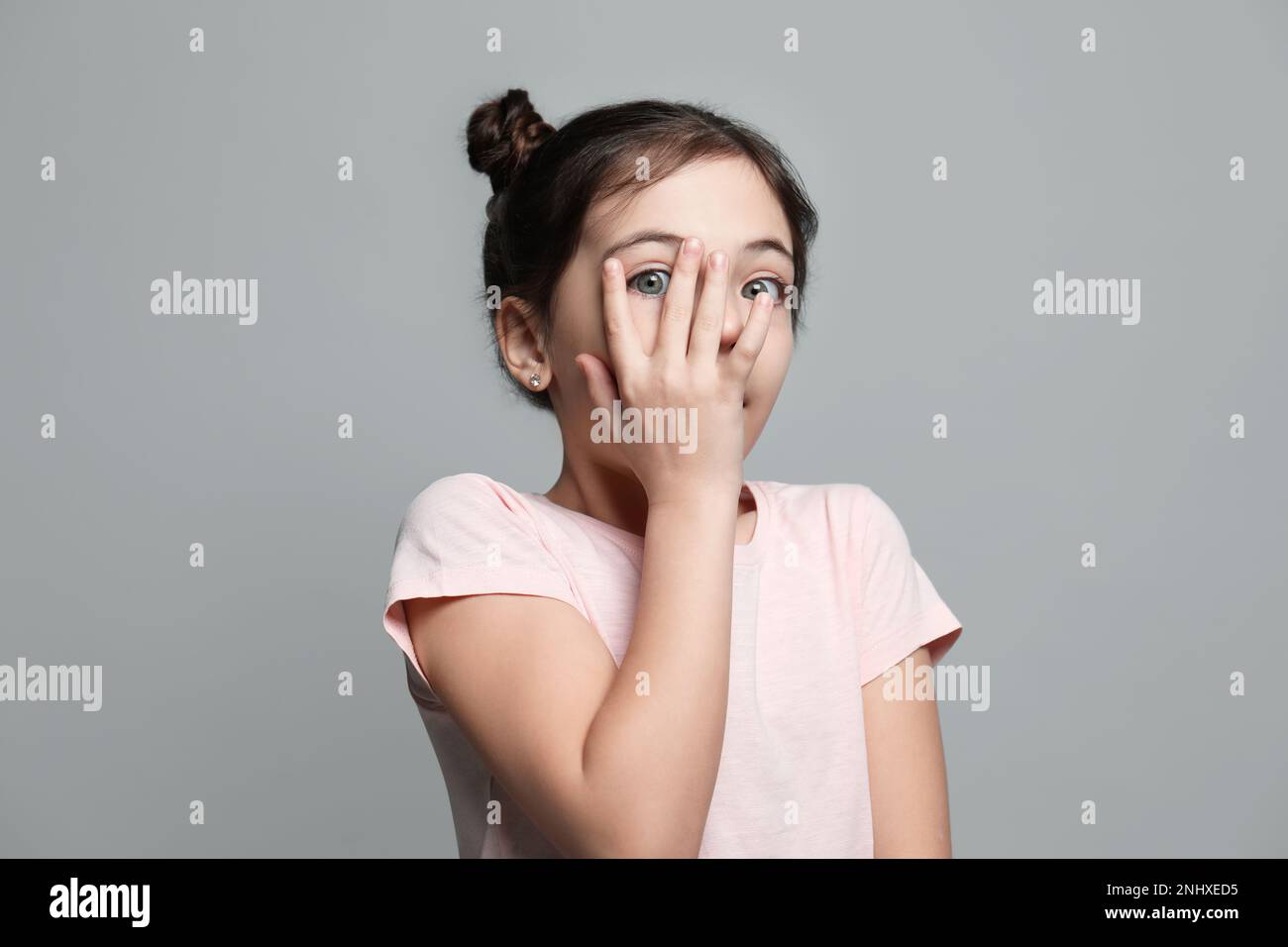 Little girl feeling fear on grey background Stock Photo - Alamy