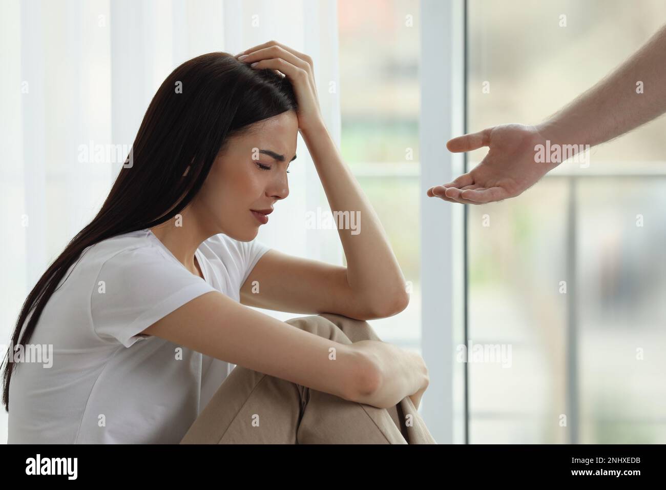 Woman offering help man sitting hi-res stock photography and images - Alamy