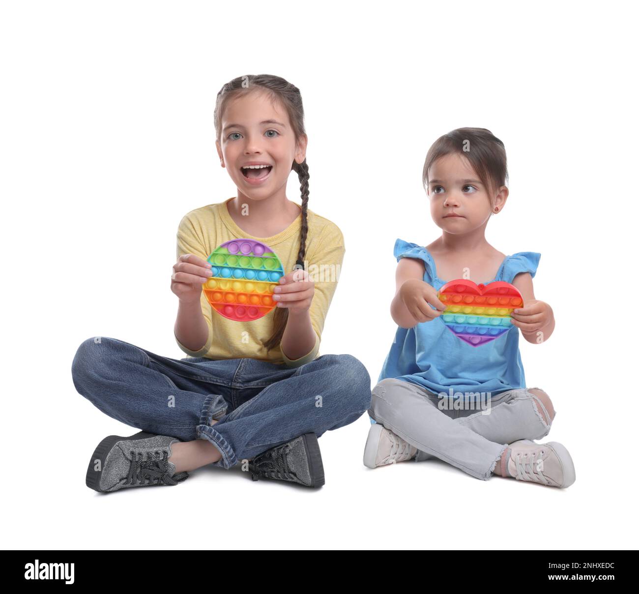 Little girls with pop it fidget toys on white background Stock Photo ...