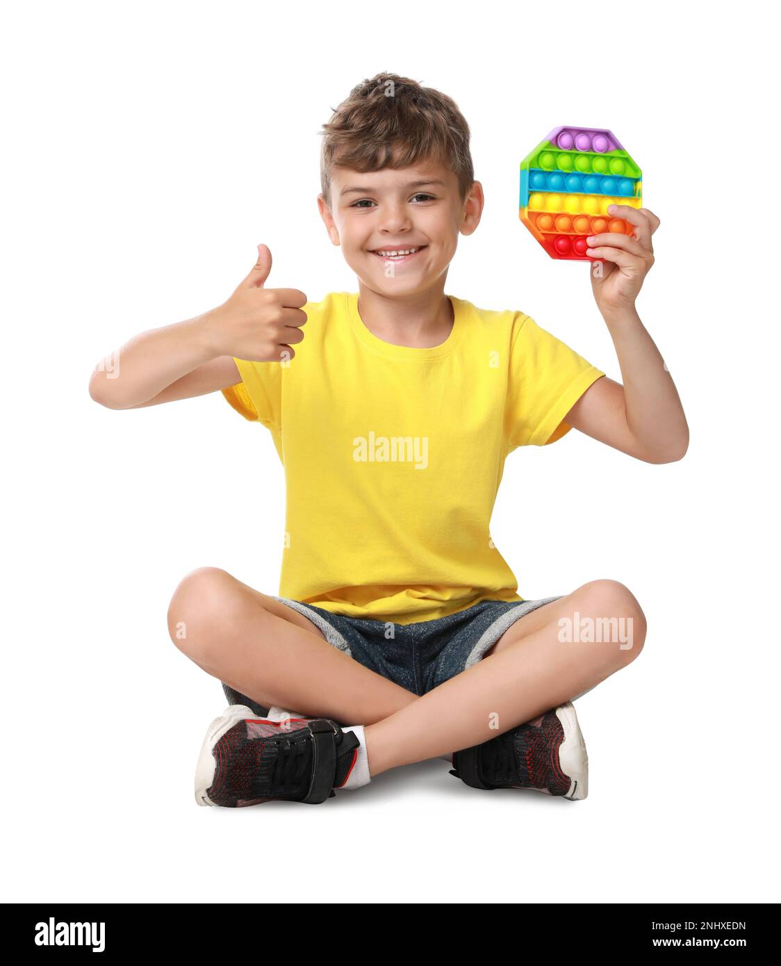 Boy with pop it fidget toy on white background Stock Photo - Alamy
