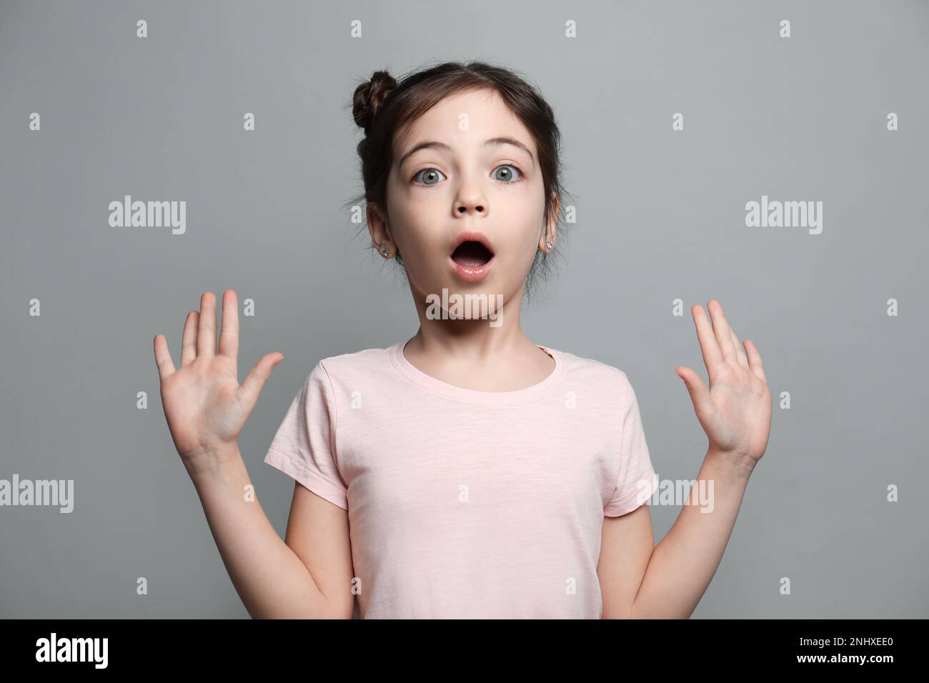 Little girl feeling fear on grey background Stock Photo - Alamy