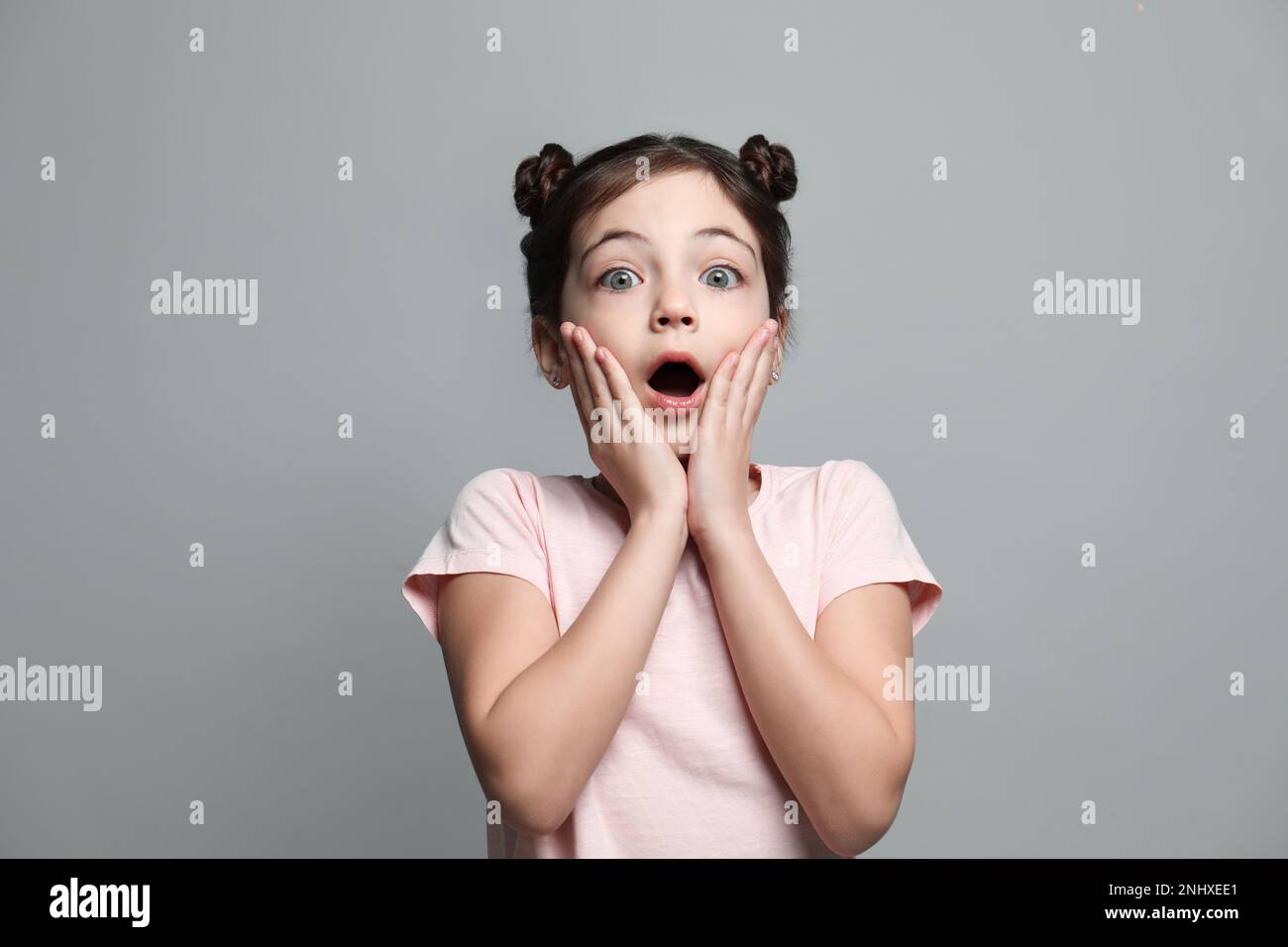 Little girl feeling fear on grey background Stock Photo - Alamy