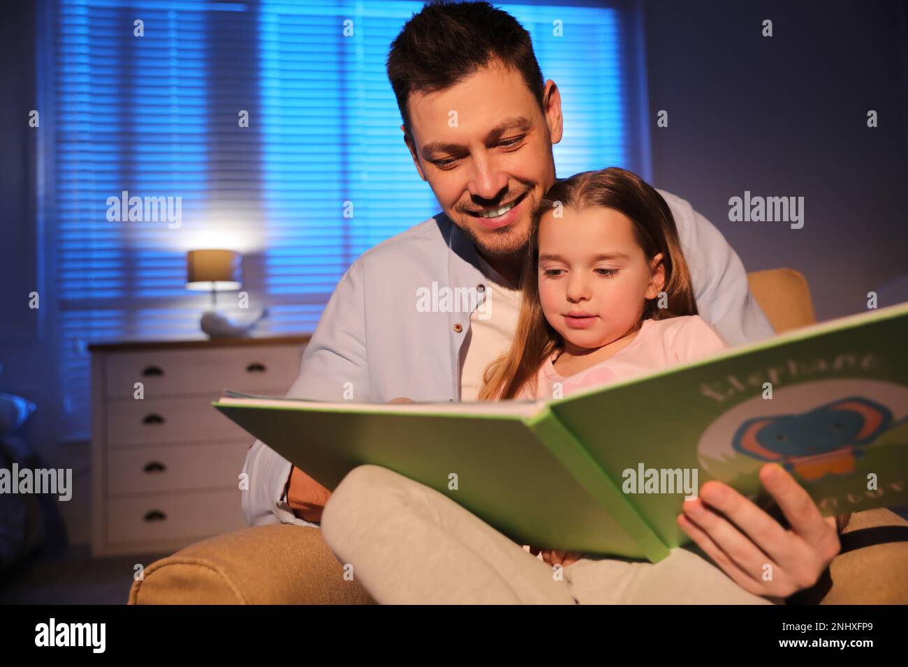 Father reading bedtime story to his daughter at home Stock Photo - Alamy