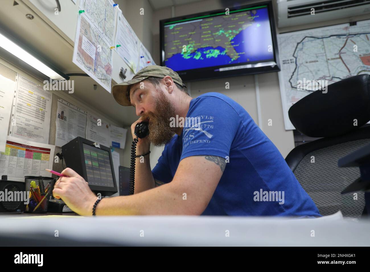 Timothy Brady, a fire desk operator with Range Control, communicates ...