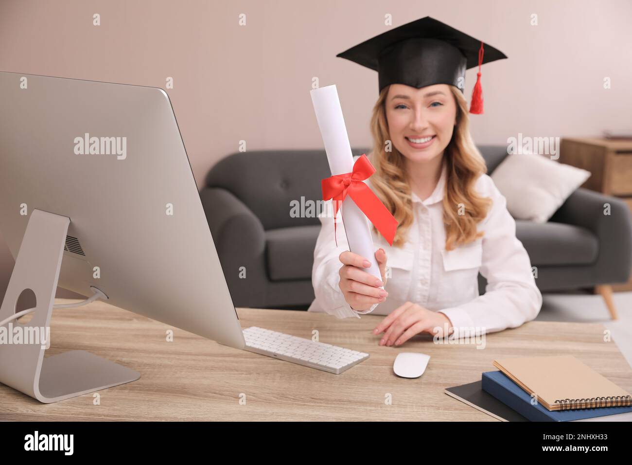 Happy student with graduation hat at workplace in office, focus on ...