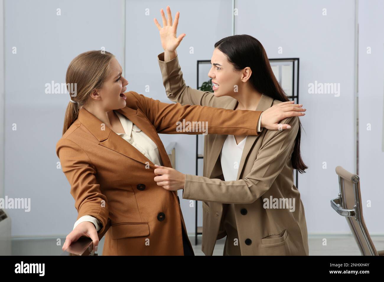 Emotional colleagues fighting in office. Workplace conflict Stock Photo ...