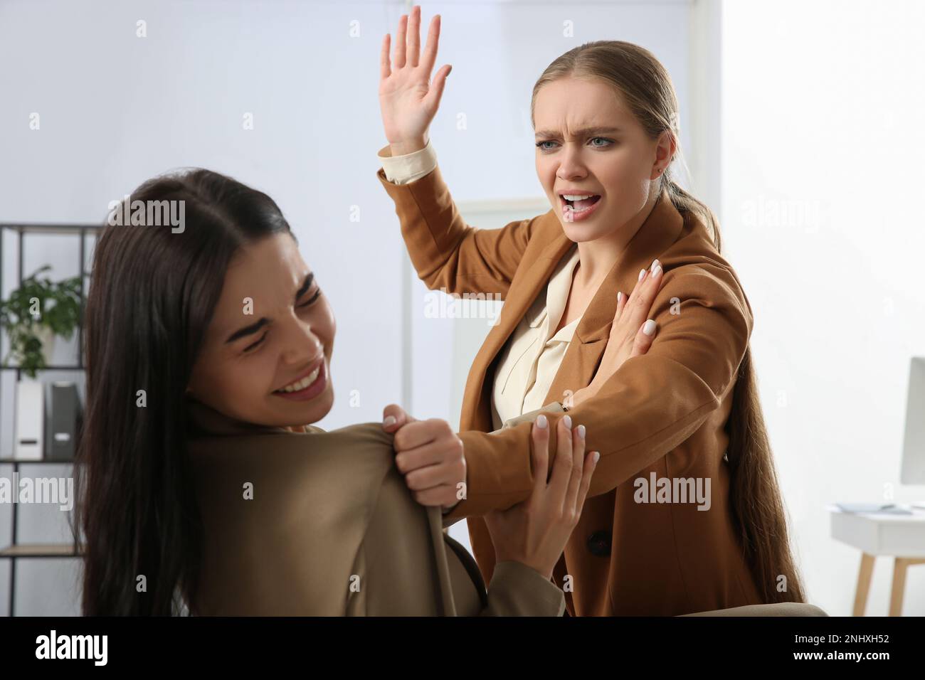 Emotional colleagues fighting in office. Workplace conflict Stock Photo ...
