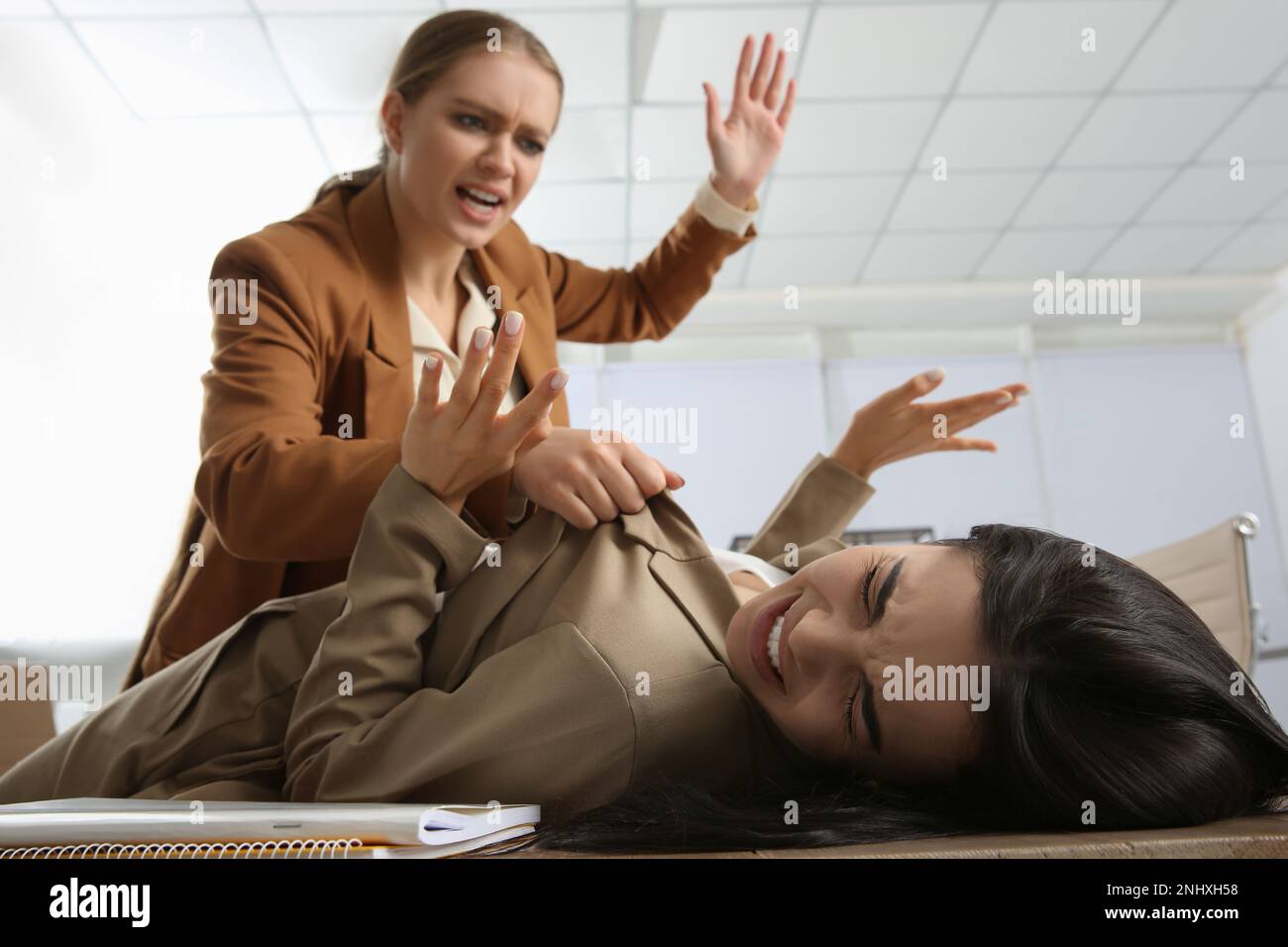 Emotional colleagues fighting in office. Workplace conflict Stock Photo ...