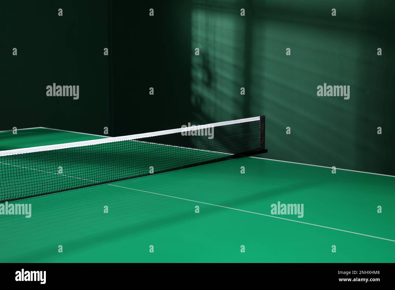 Green ping pong table with net in room, closeup Stock Photo - Alamy