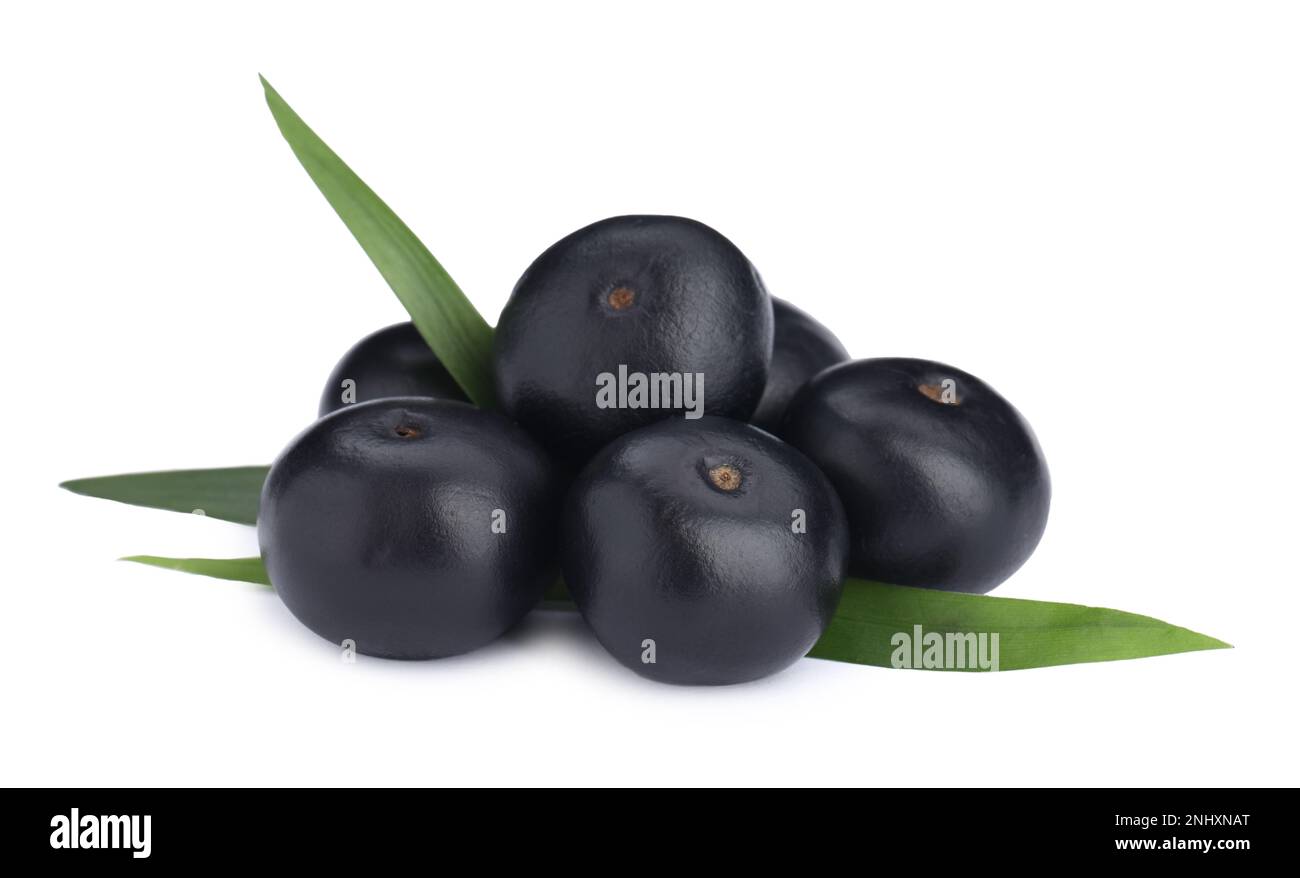 Pile of fresh ripe acai berries and green leaves on white background ...