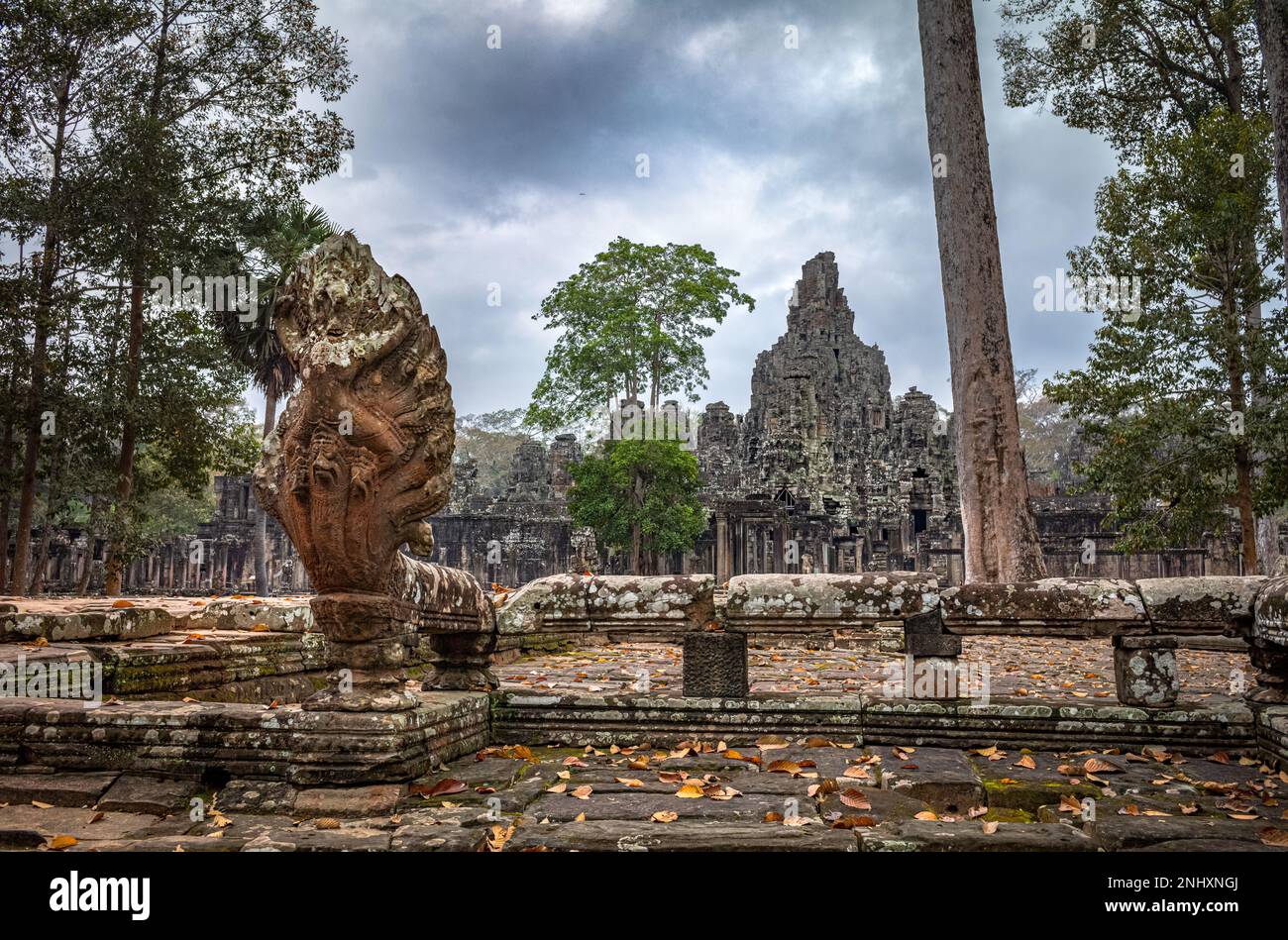 A giant Naga on a stone balustrade by an entrance to the ruins of the ...
