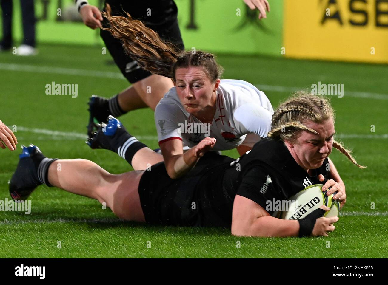 England's Lucy Packer, top, is unable to stop New Zealand's Amy Rule ...