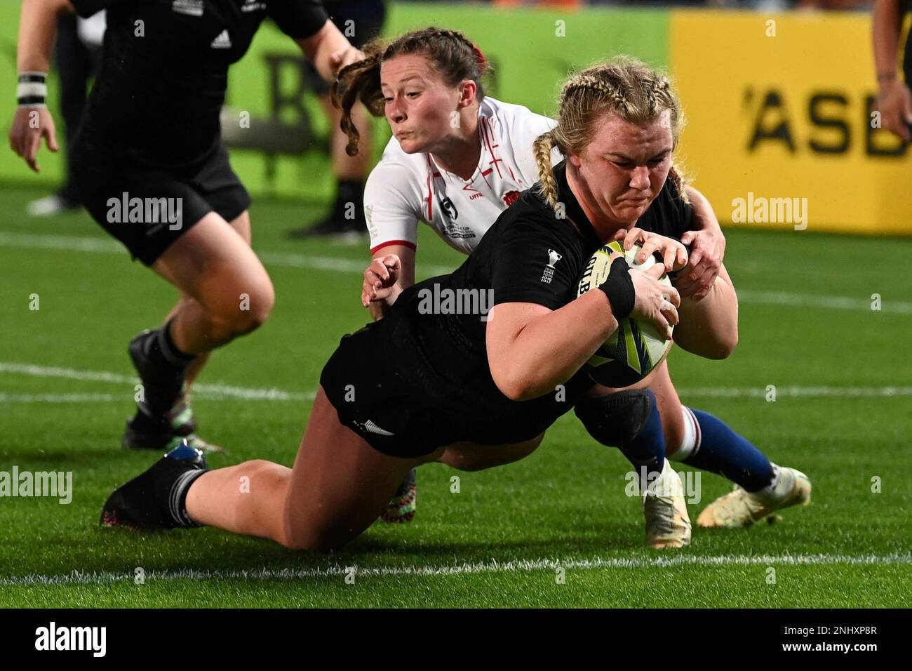 England's Lucy Packer, top, is unable to stop New Zealand's Amy Rule ...