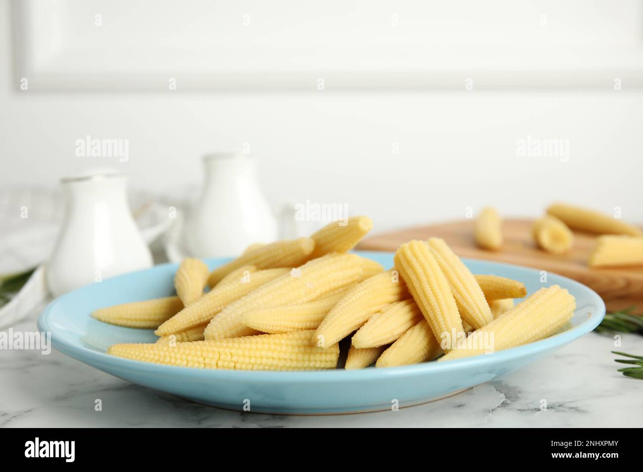 Fresh baby corn cobs on white marble table Stock Photo - Alamy