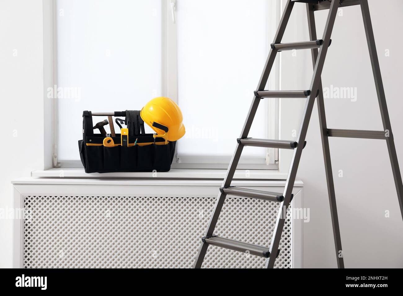 Window sill with tool box and ladder in room Stock Photo - Alamy
