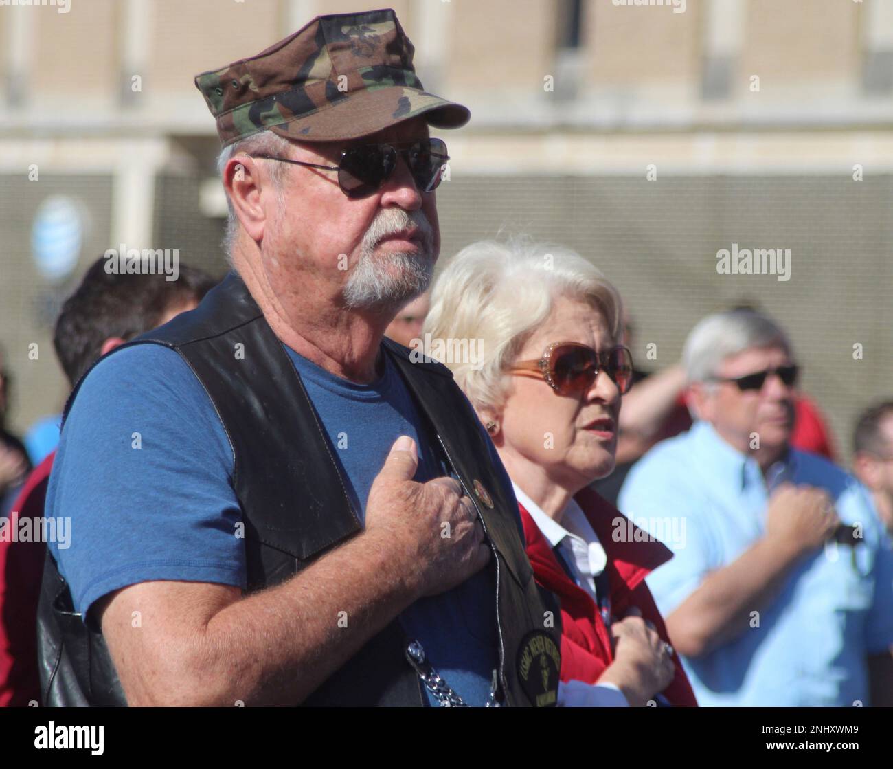 Bill and Kay Nelson pledge allegiance to the flag during a Veterans Day ...