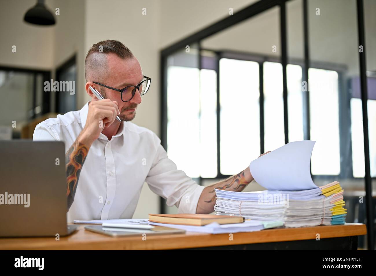 Focused Caucasian businessman or male financial analysts with tattoo on ...