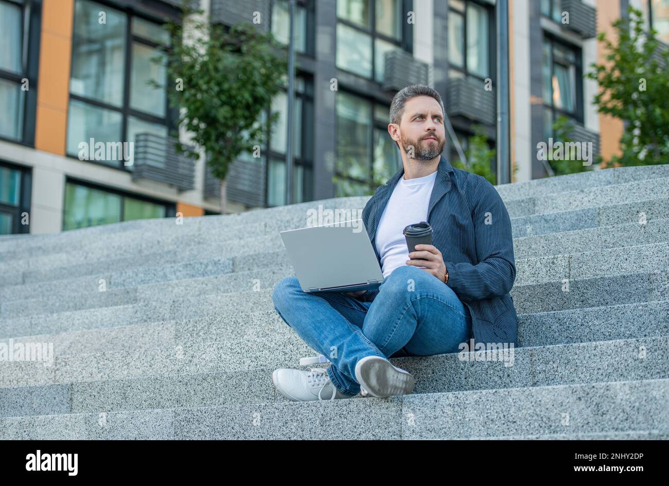 freelancer man with pc outside, advertisement. photo of freelancer man ...