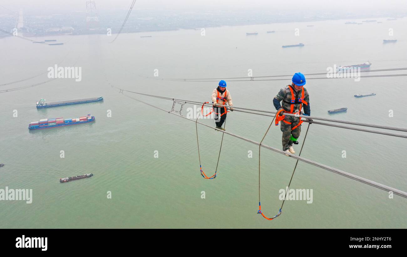 Aerial photo shows workers checking the wires of the world's highest transmission tower in Wuxi ...