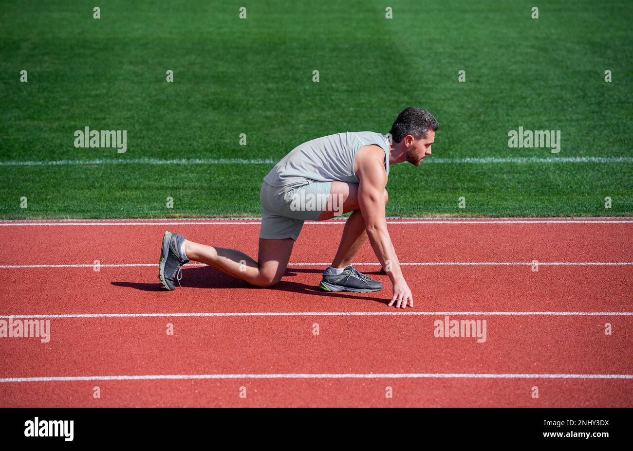 Runner ready to go. Athlete runner prepare to race at stadium. Running ...