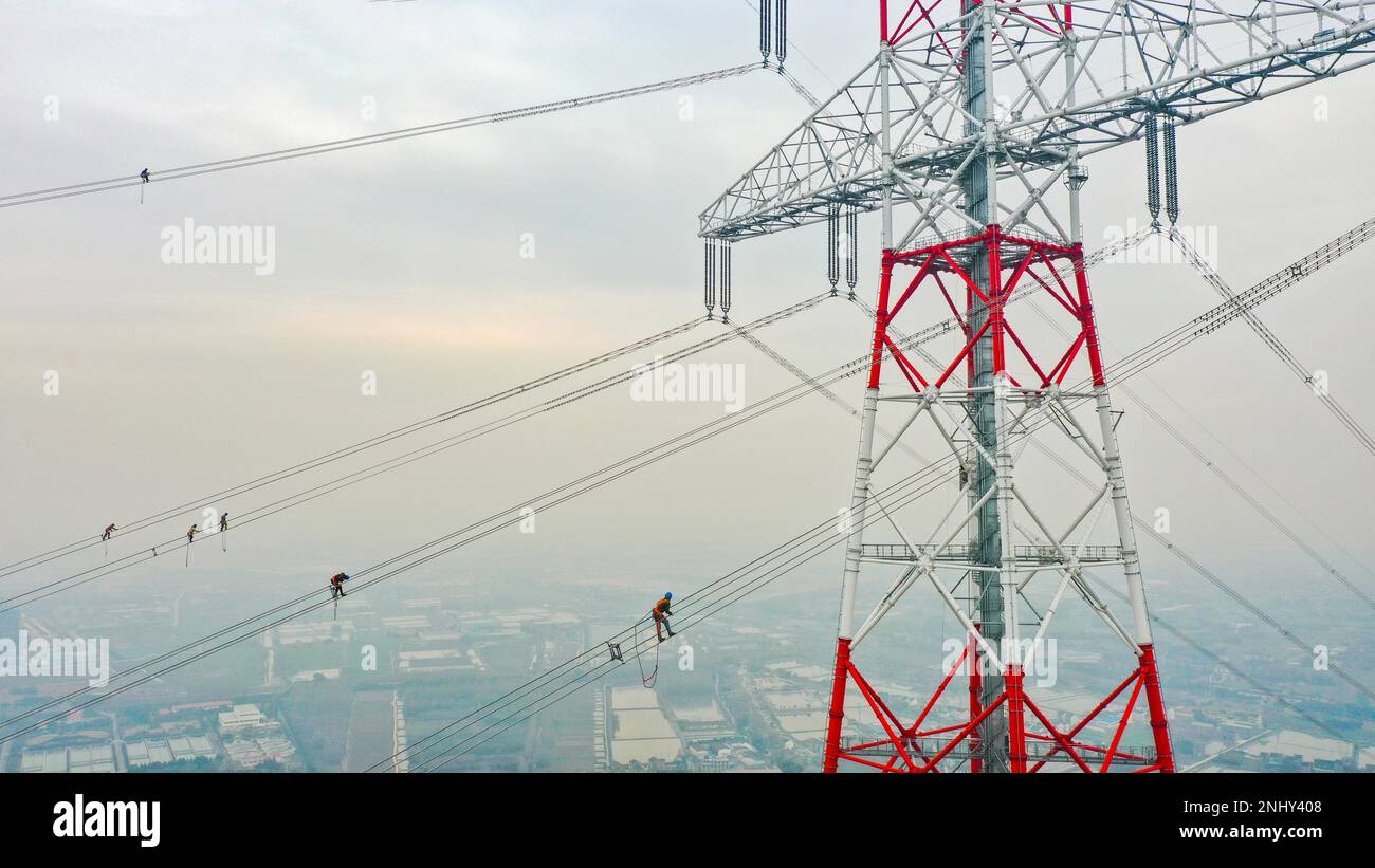 Aerial photo shows workers checking the wires of the world's highest transmission tower in Wuxi ...