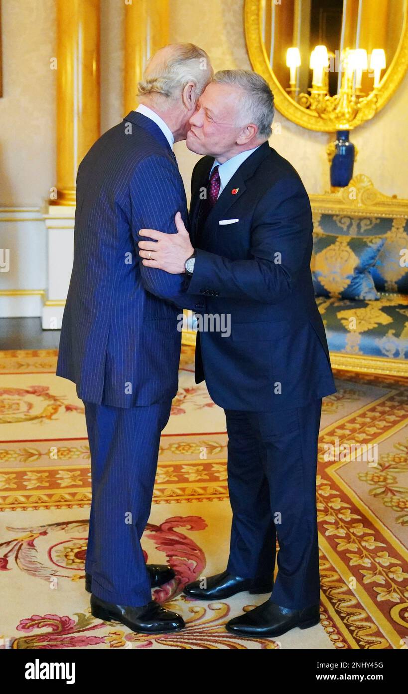 Britain's King Charles III, left, is kissed by King Abdullah II of ...