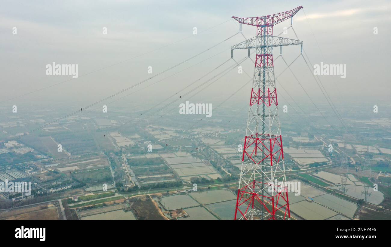 Aerial photo shows workers checking the wires of the world's highest transmission tower in Wuxi ...
