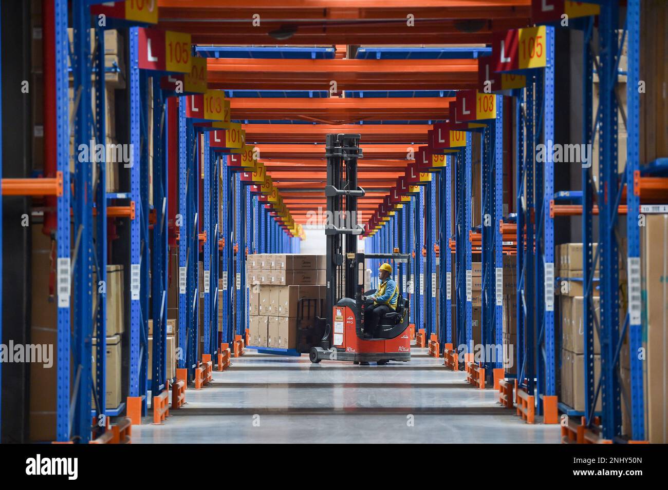 A worker operates a forklift at a logistics center of Suning in Nanjing ...